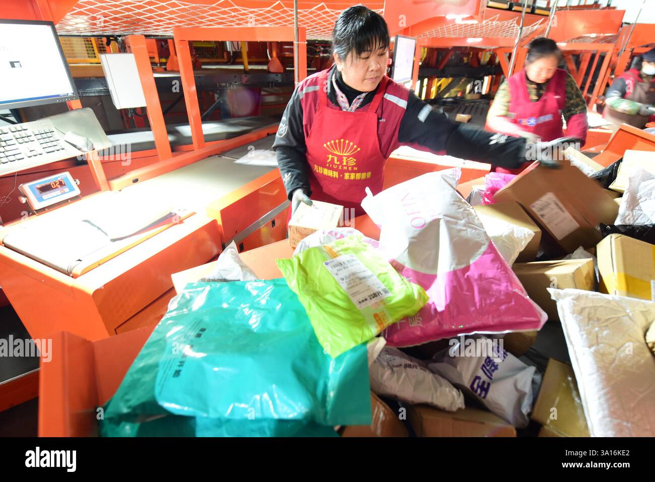 Female workers sort express packages at a logistics park in Lianyungang ...