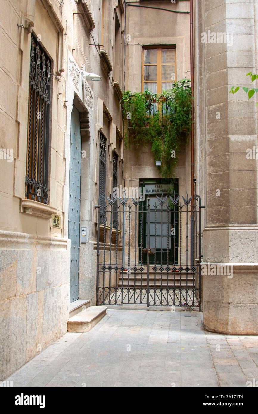 Urban detail in Barcelona with a gated courtyard and architectural ...