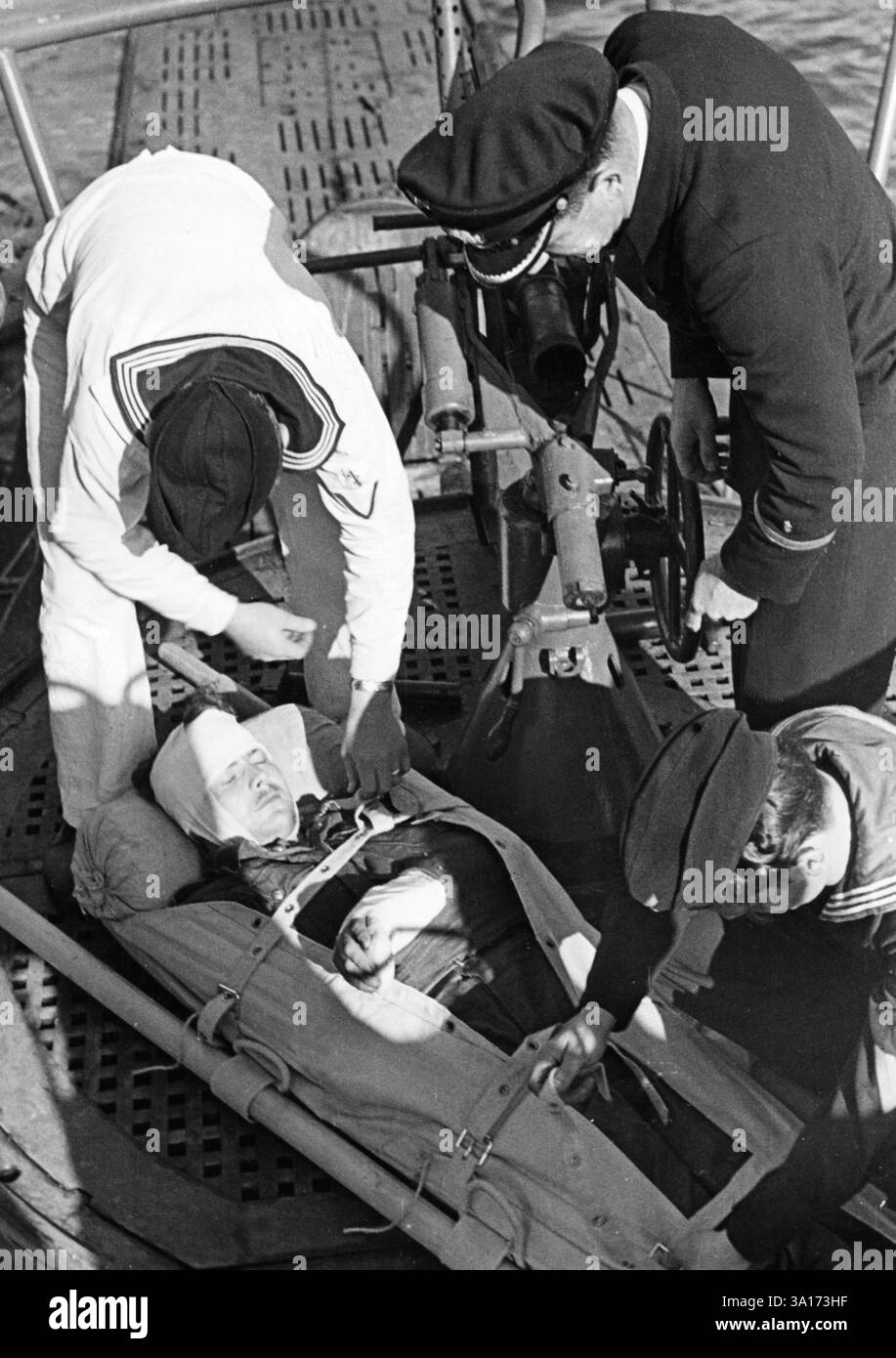 A wounded sailor is taken off a German submarine. Undated photograph ...