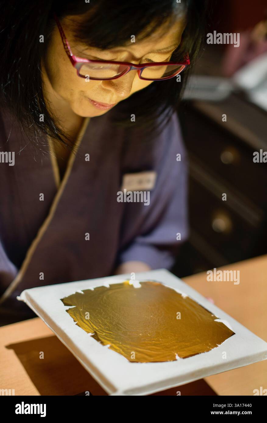 Kuniko Kawamura lightly blows a 0.0001 mm thick sheet of gold leaf in a process called "haku ...