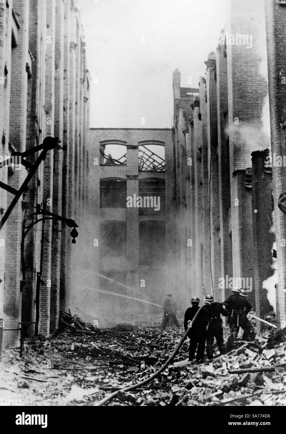 Firefighters in a factory destroyed in an air raid. [automated ...