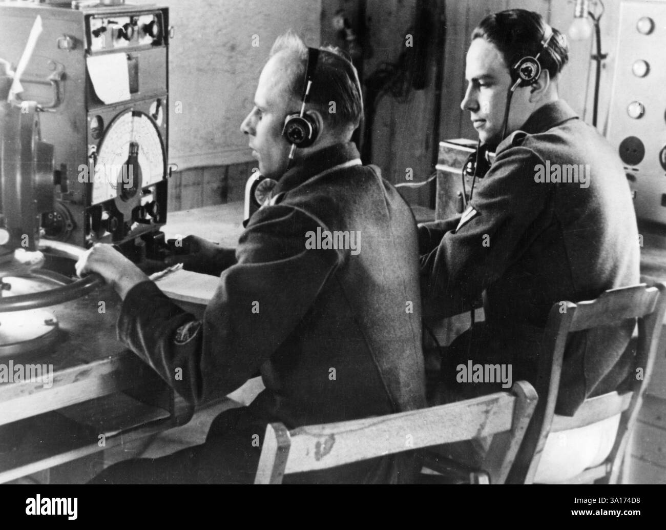 Direction finding radio operators at their equipment at a field airport ...