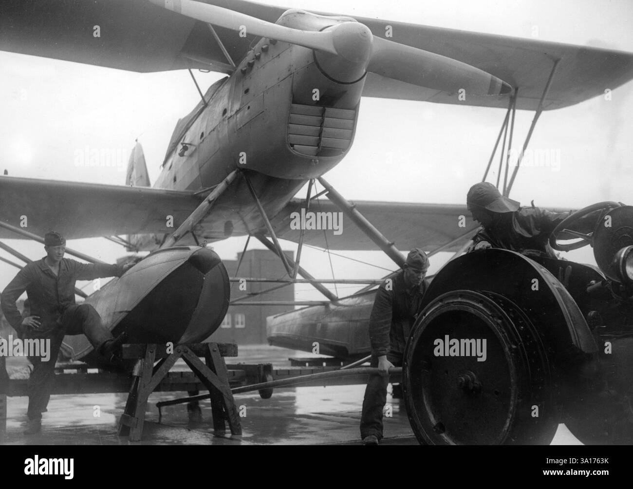 At a naval air base, a Heinkel He 60 is brought to the water with a ...