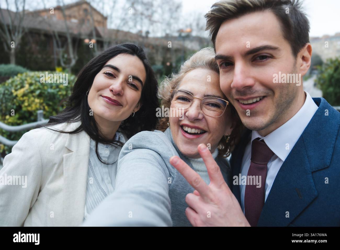 Happy family taking selfie outdoors making victory sign Stock Photo - Alamy