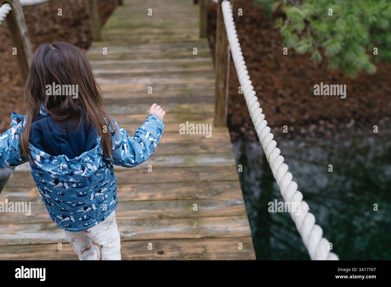 Child carefully walking, crossing over a bridge in Indiana, USA Stock ...