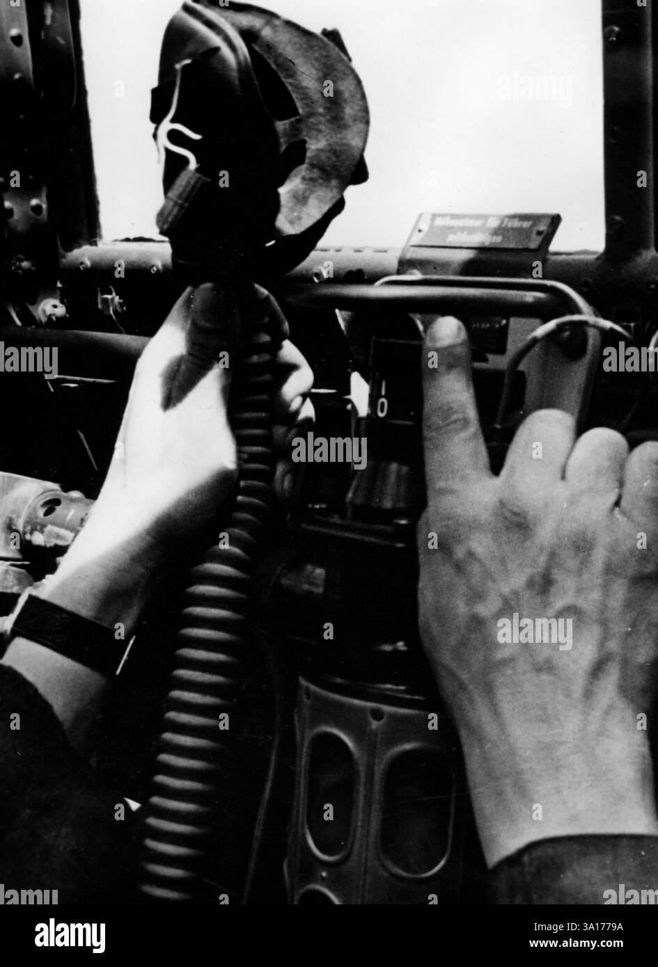 A soldier in a German long-range reconnaissance aircraft adjusts the ...