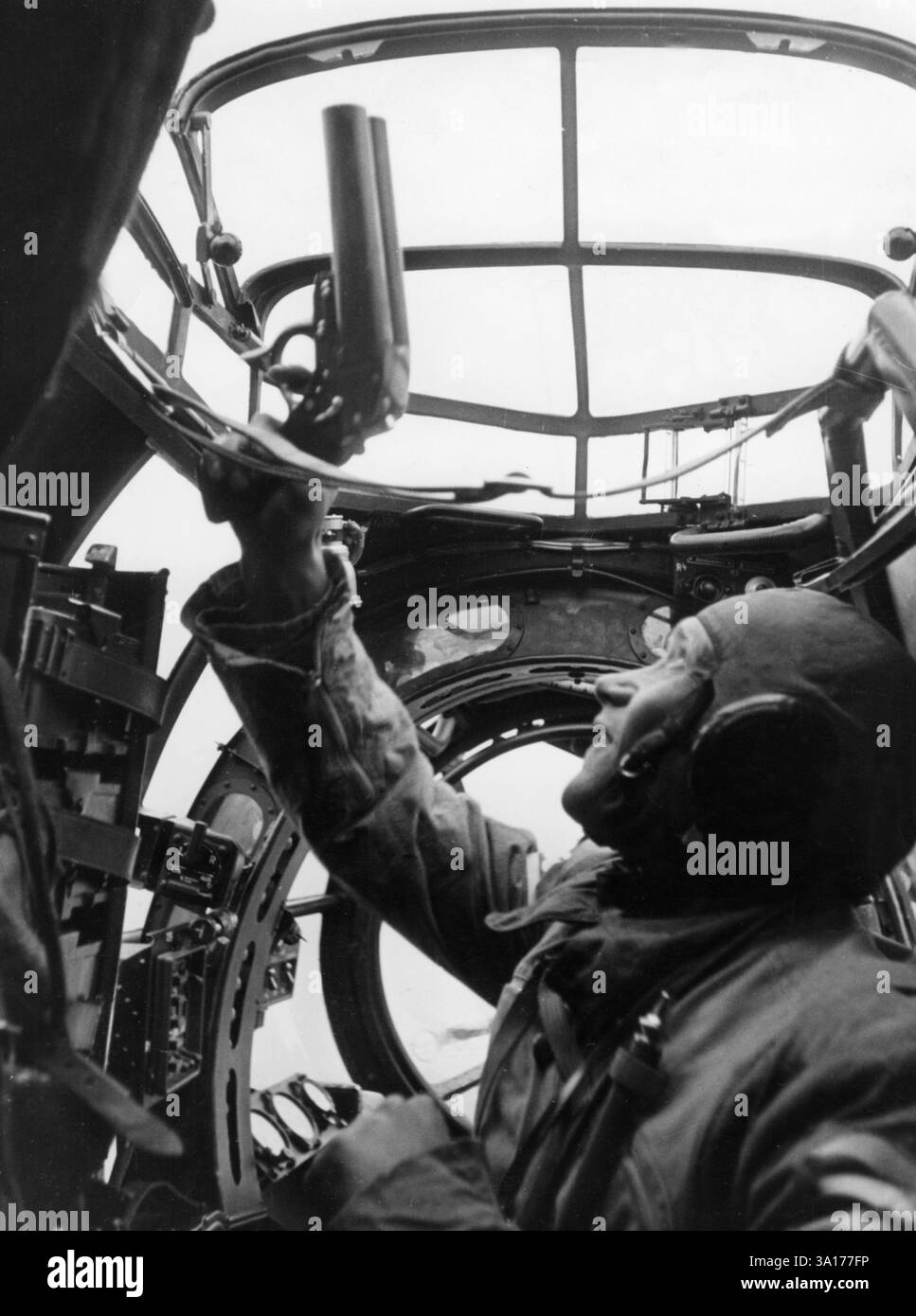 A crew member shoots flares from the cockpit of a German bomber ...