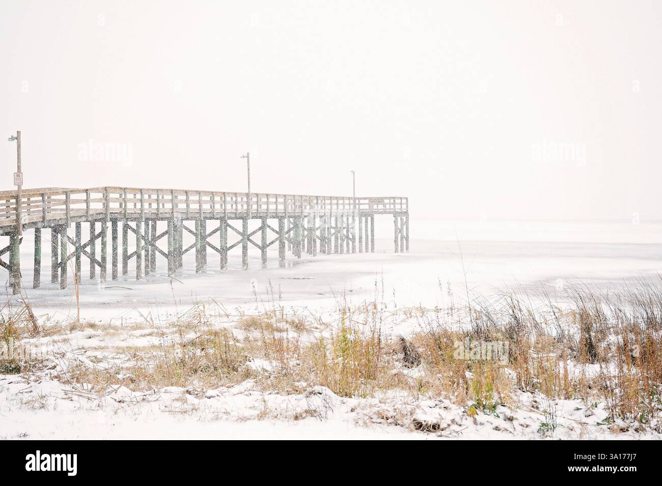 Snow-covered pier in a rare Gulf Coast winter scene Stock Photo - Alamy