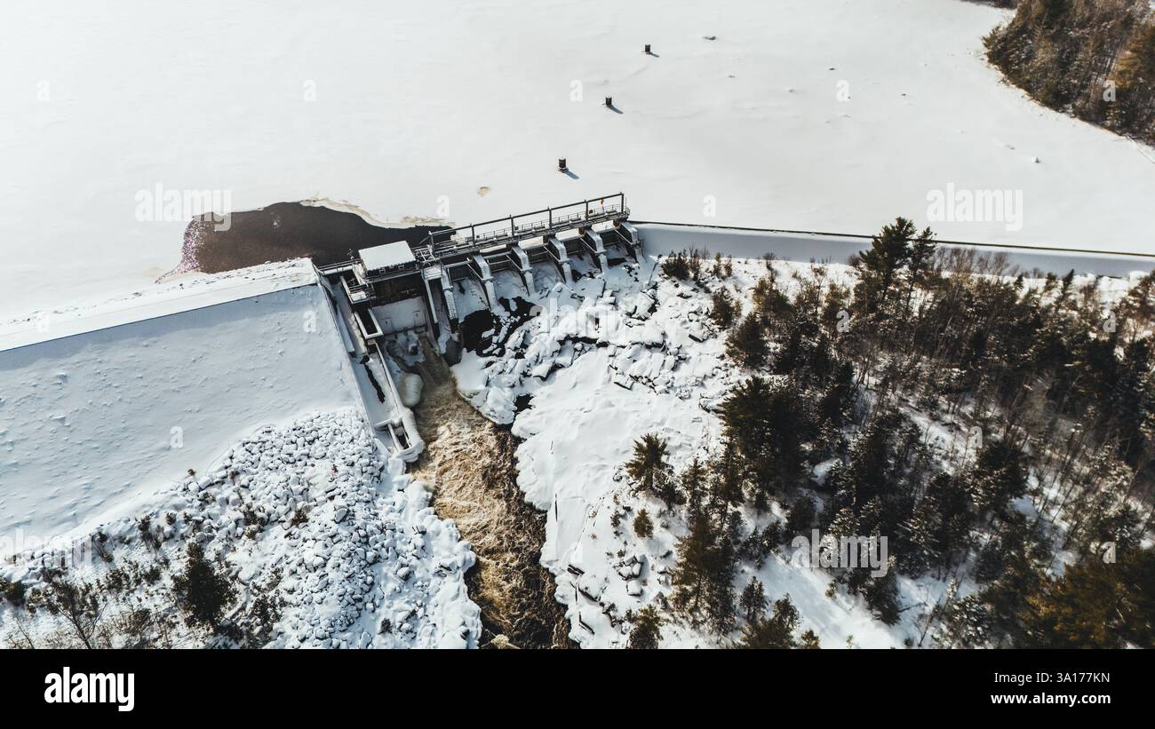 Aerial view of hydroelectric dam generating renewable energy in winter ...