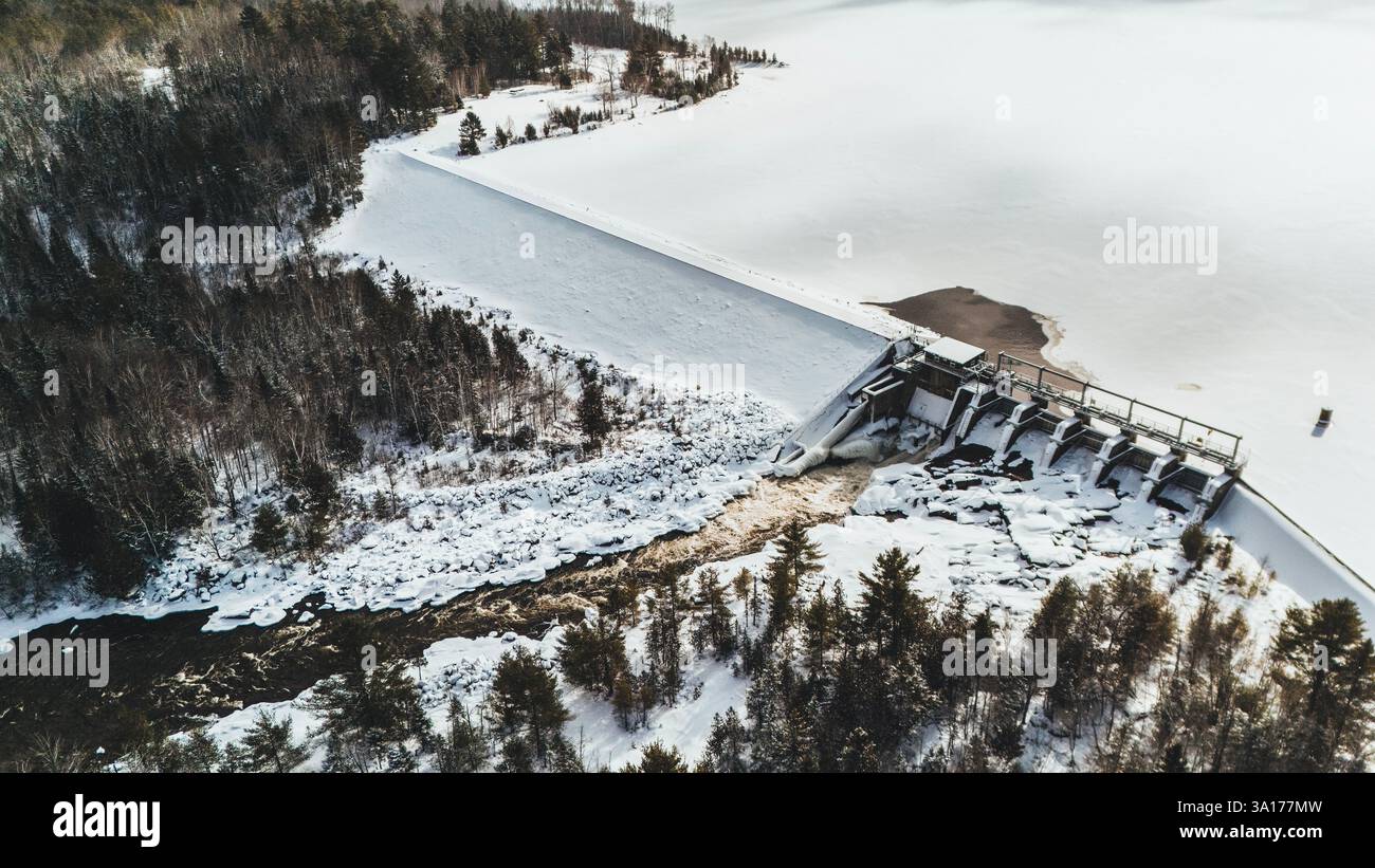 Snow covered hydro station with lake and river in winter, Maine Stock ...