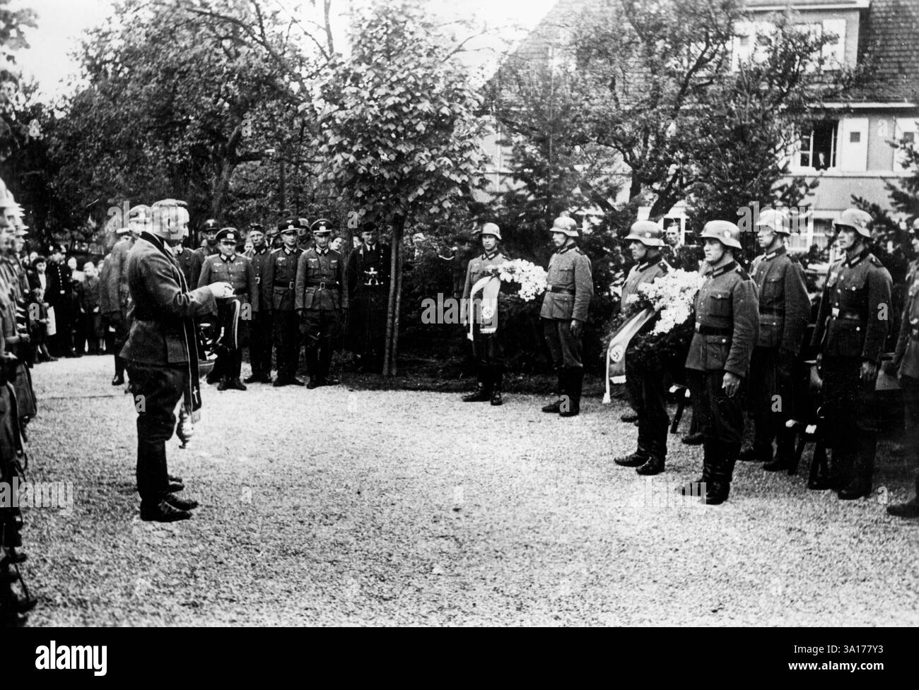 A Wehrmacht priest in front of the wreaths for downed British aircrew ...