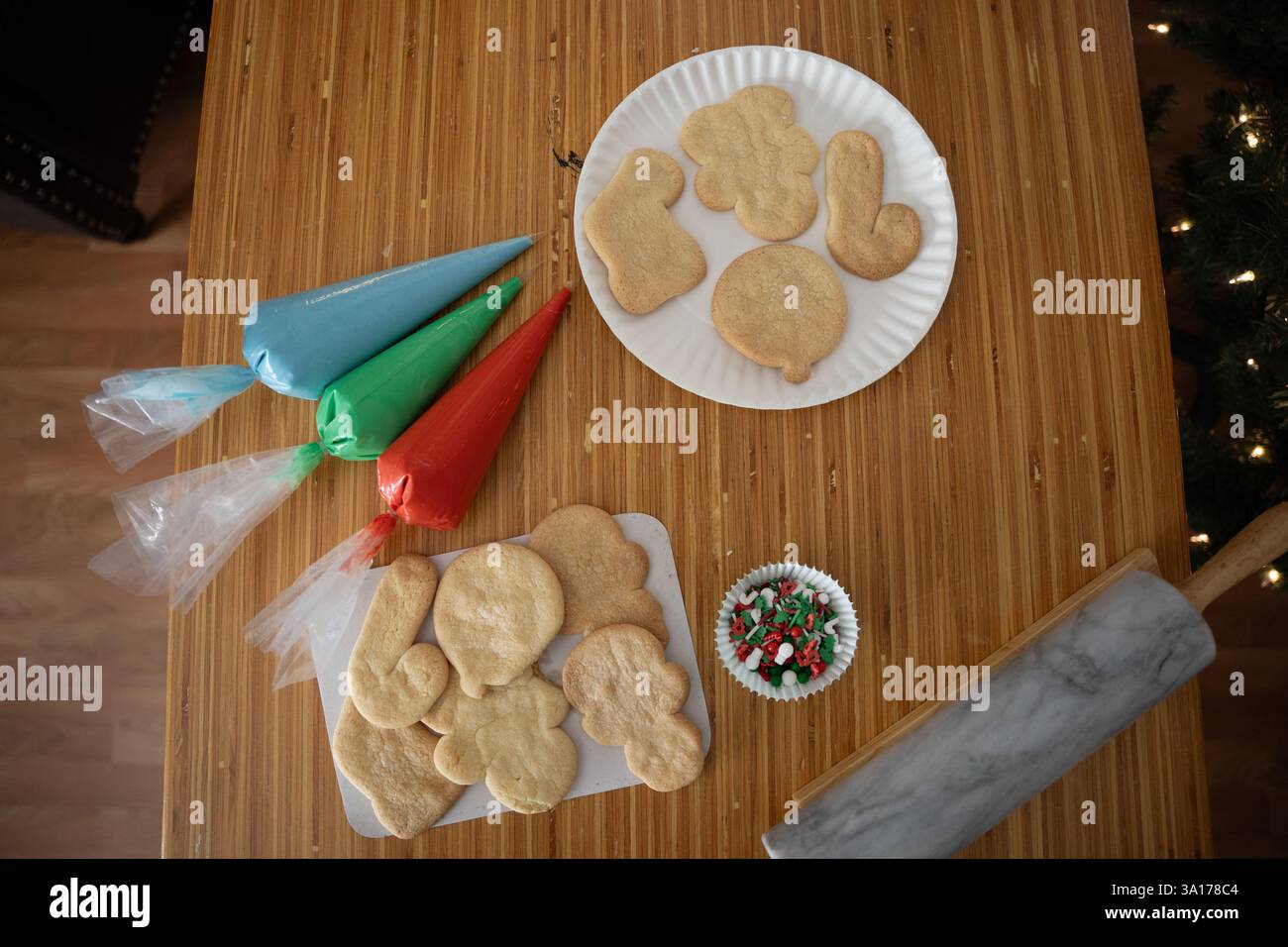 Christmas cookie decorating setup with icing and festive sprinkles ...
