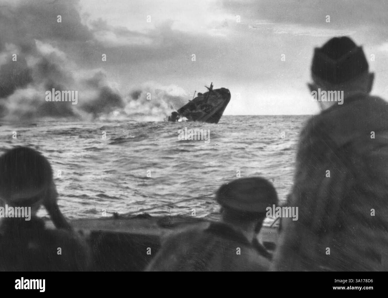 The crew of a submarine observes a sinking freighter south of ...