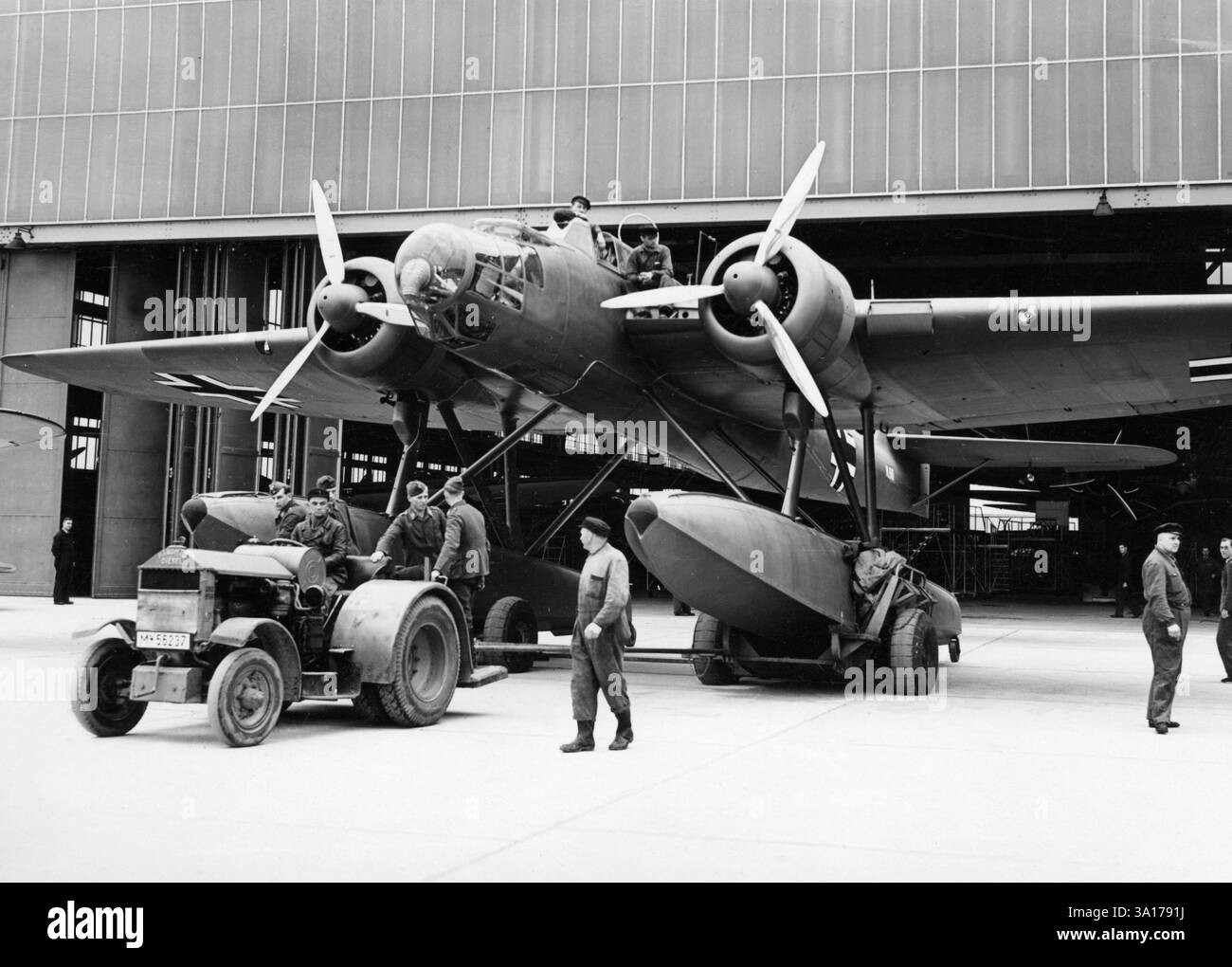 A tractor pulls a Heinkel He 115 of the German Air Force out of a ...