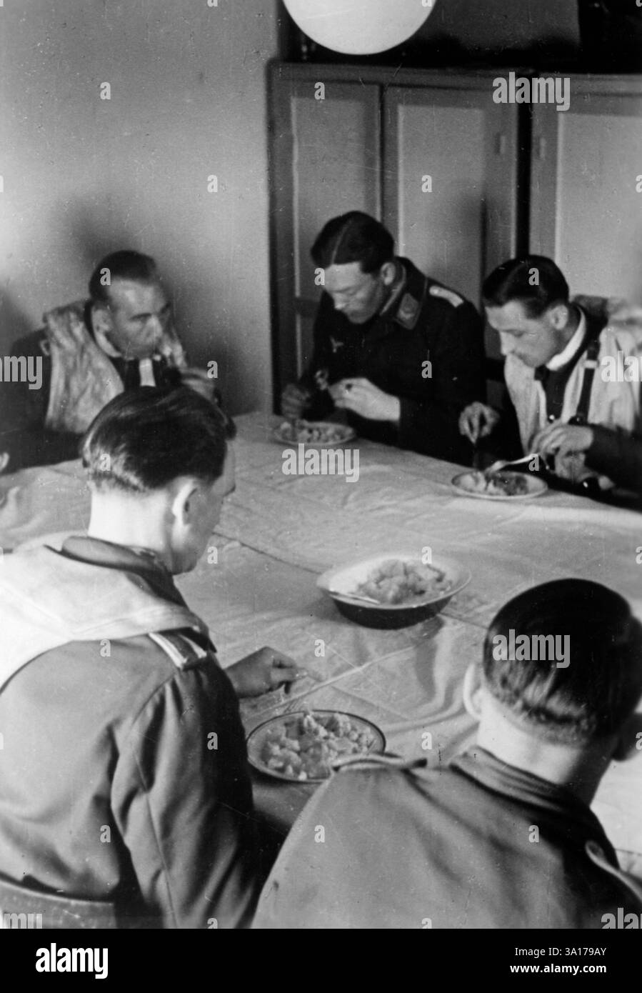 German soldiers eating in full flying gear while waiting for the order ...