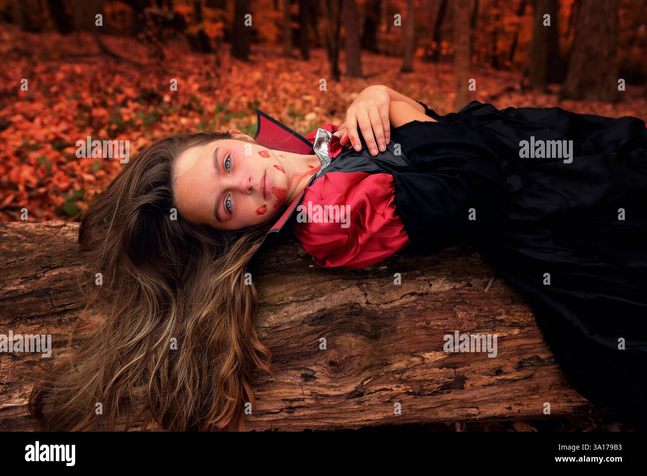 Beautiful tween girl in Vampire costume colorful forest Stock Photo - Alamy