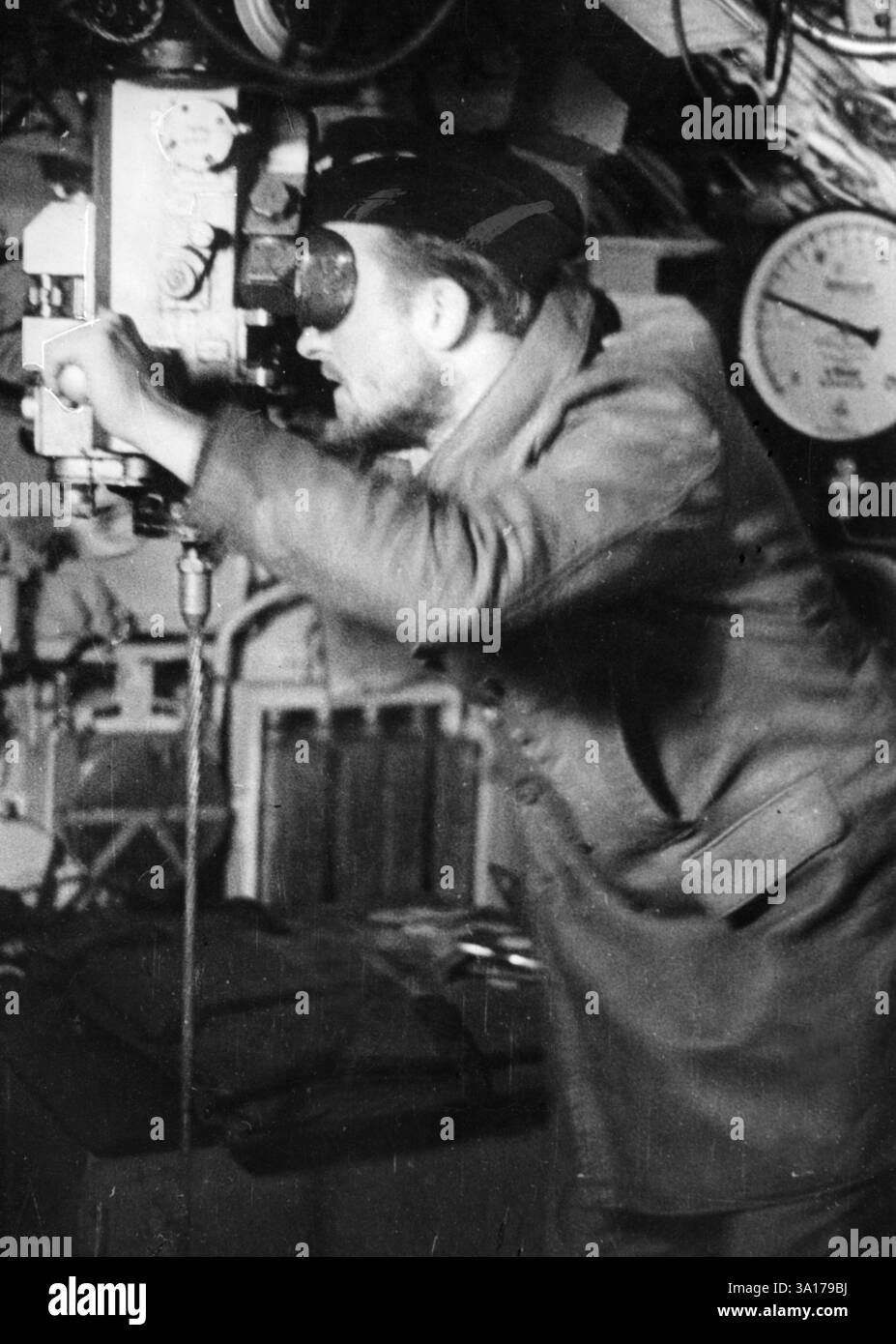 The commander of a German submarine at the periscope in the control ...