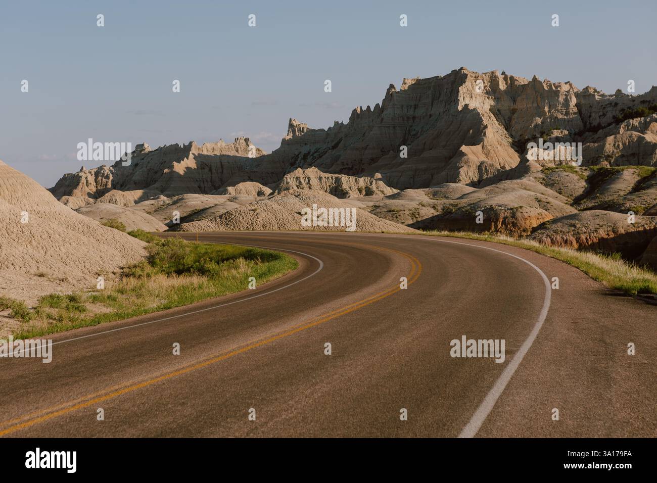 Winding road through rugged Badlands landscape in golden sunlight Stock Photo - Alamy