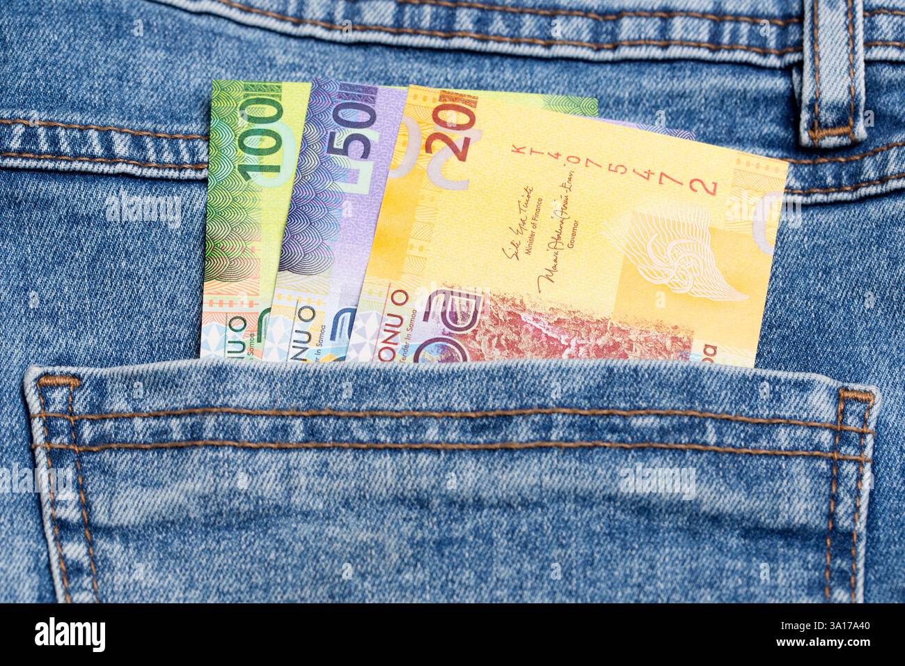 Samoan money - tala in the pocket of blue jeans Stock Photo - Alamy