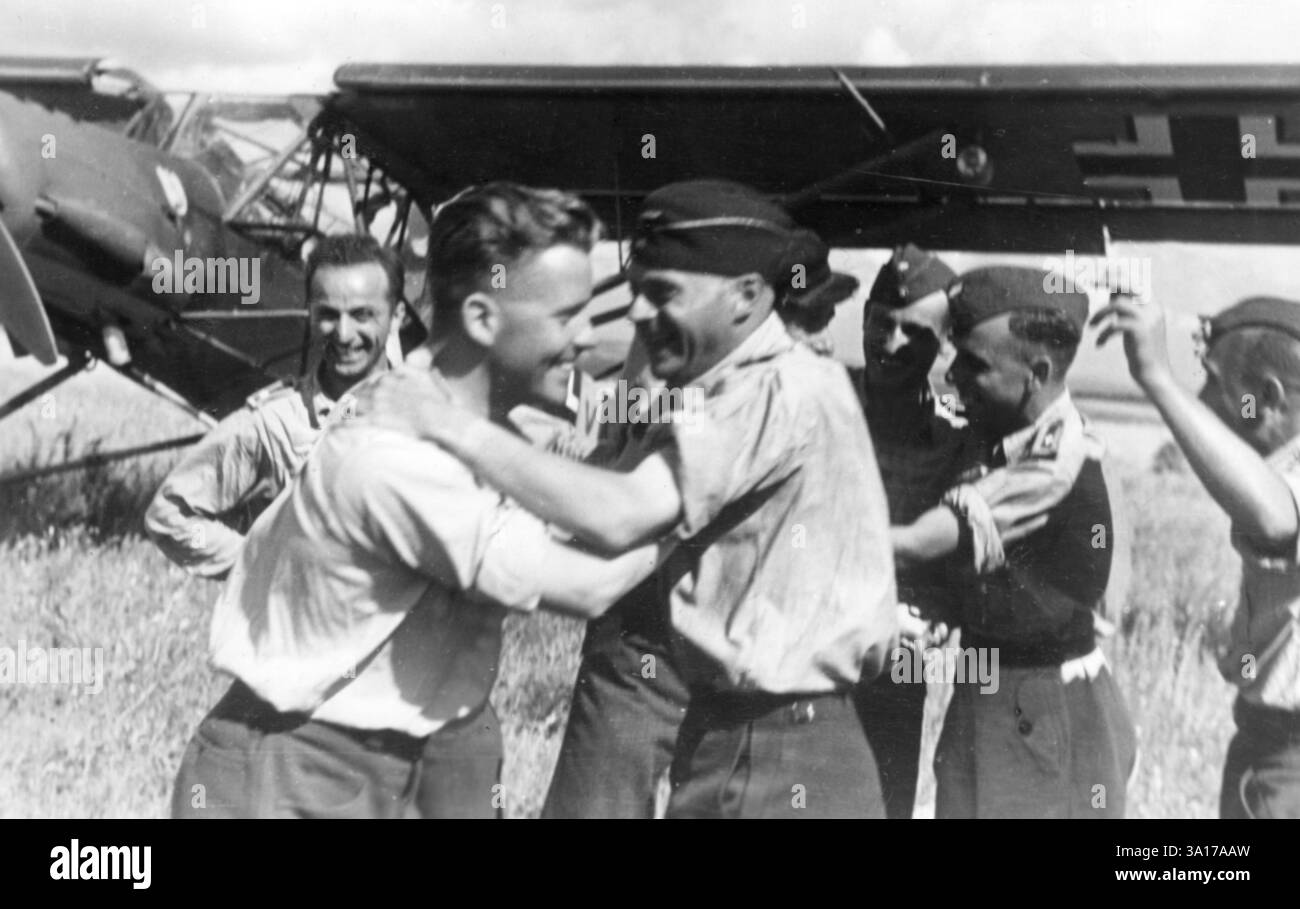The crew of a Junkers Ju 87 Stuka is greeted by their squadron comrades ...