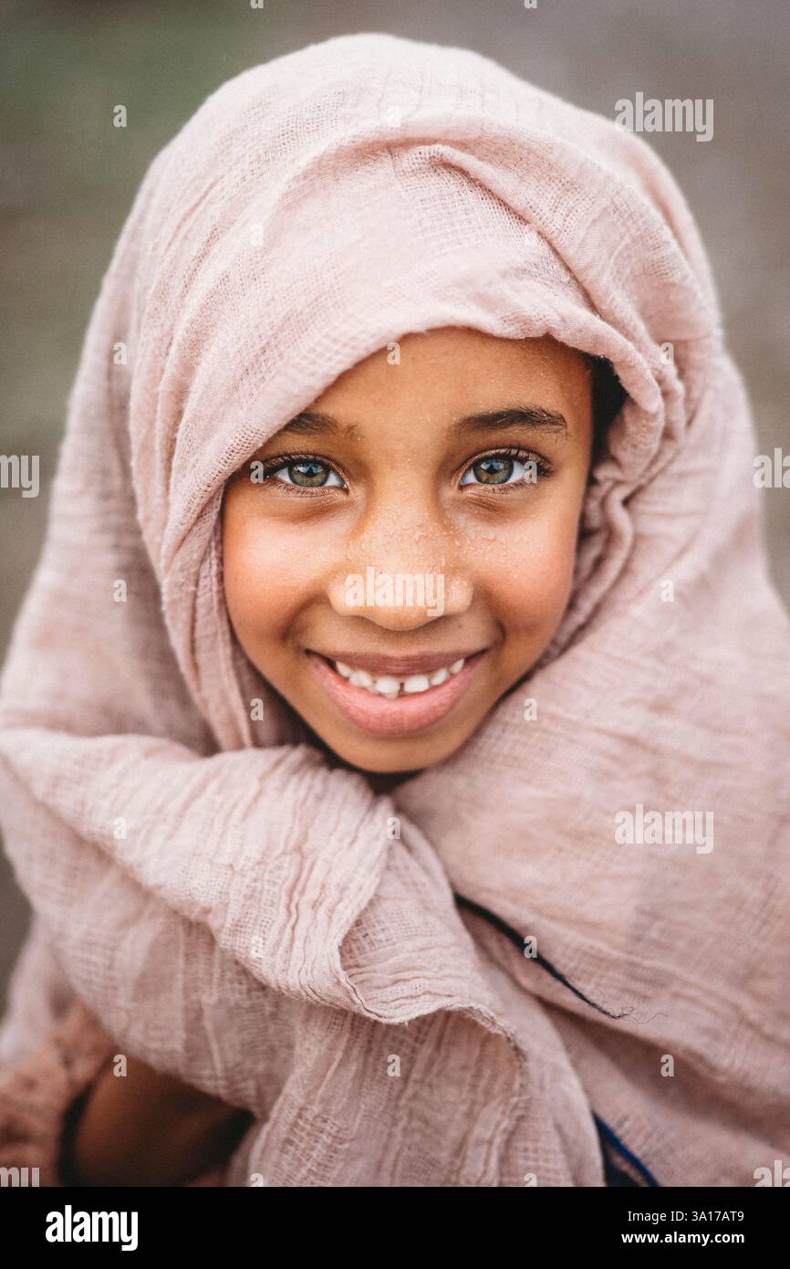 Black girl green eyes scarf on head outside countryside rainy day Stock ...