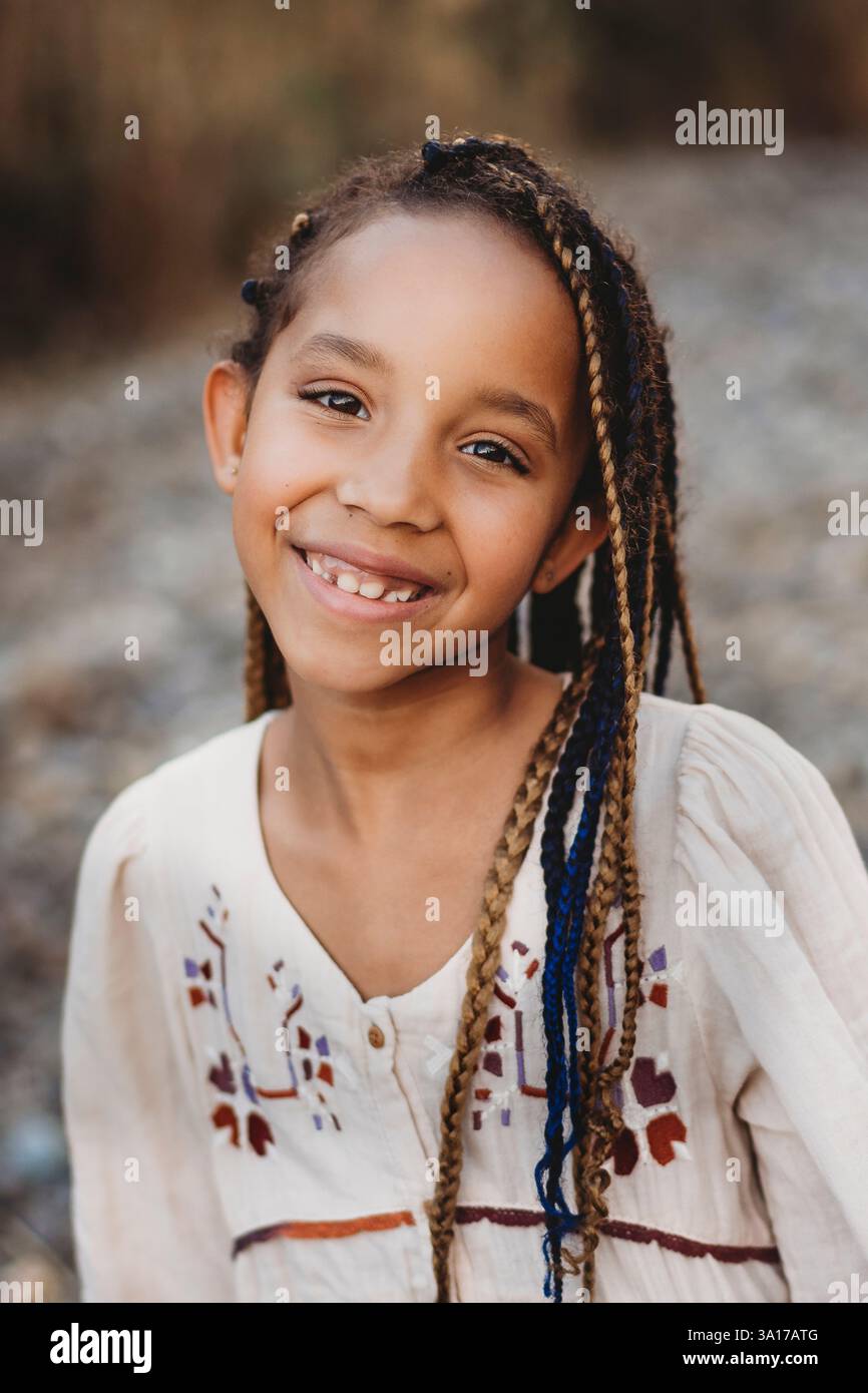 Multiracial black mixed race girl smiling in fields summer Stock Photo ...