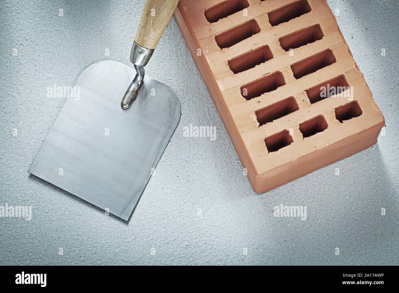 Red brick plastering trowel on concrete surface bricklaying concept ...