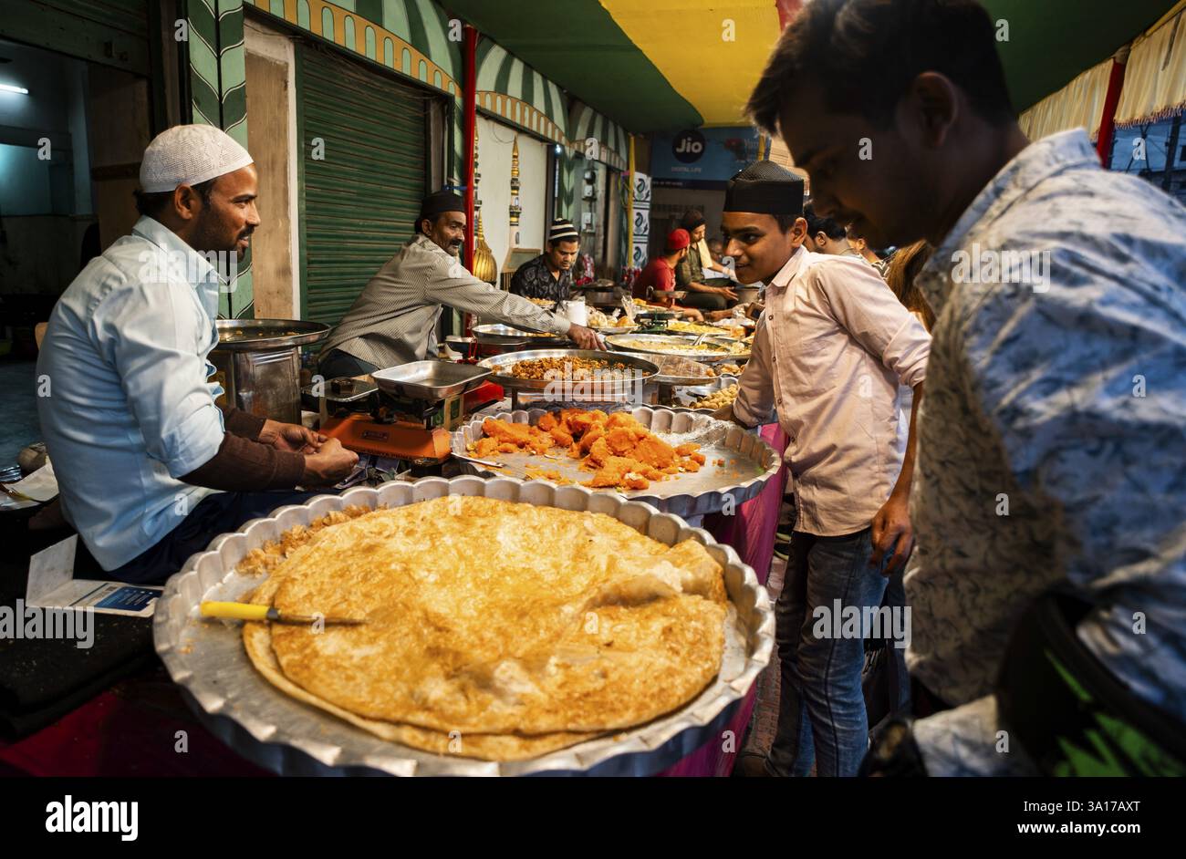 Muslims buy food at a stall to have Ramadan's Iftar during Muslim holy ...