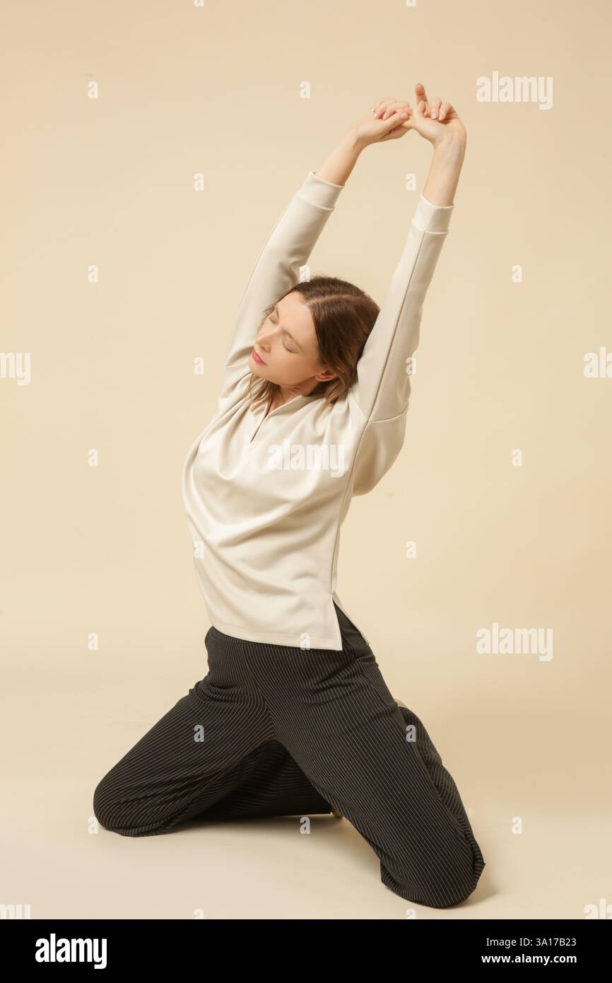 Female model wearing striped black and white trousers and white shirt ...