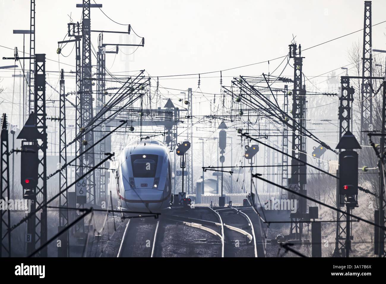 Deutsche Bahn AG tracks with ICE train against the light. Overhead line ...
