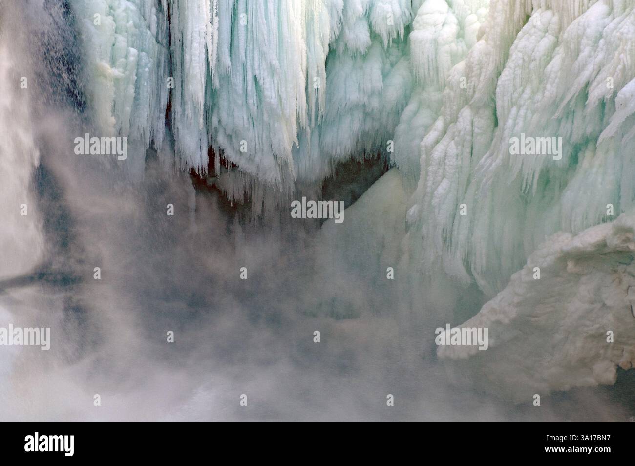 Frozen waterfalls with blue ice and misty atmosphere, winter, Sweden's ...