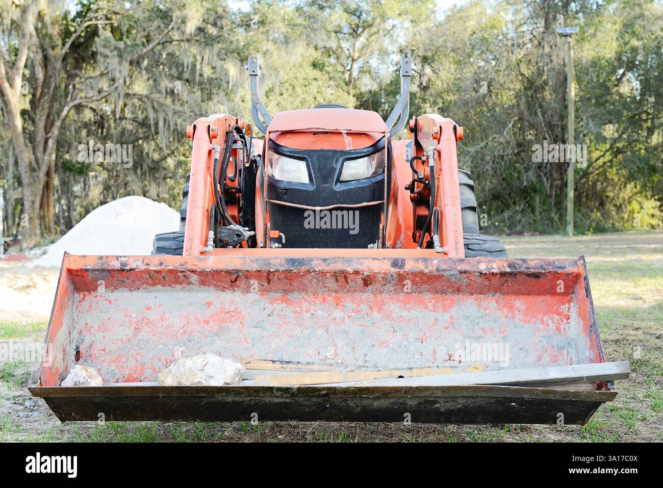 Orange front-loader tractor at a construction site with dirt and Stock ...