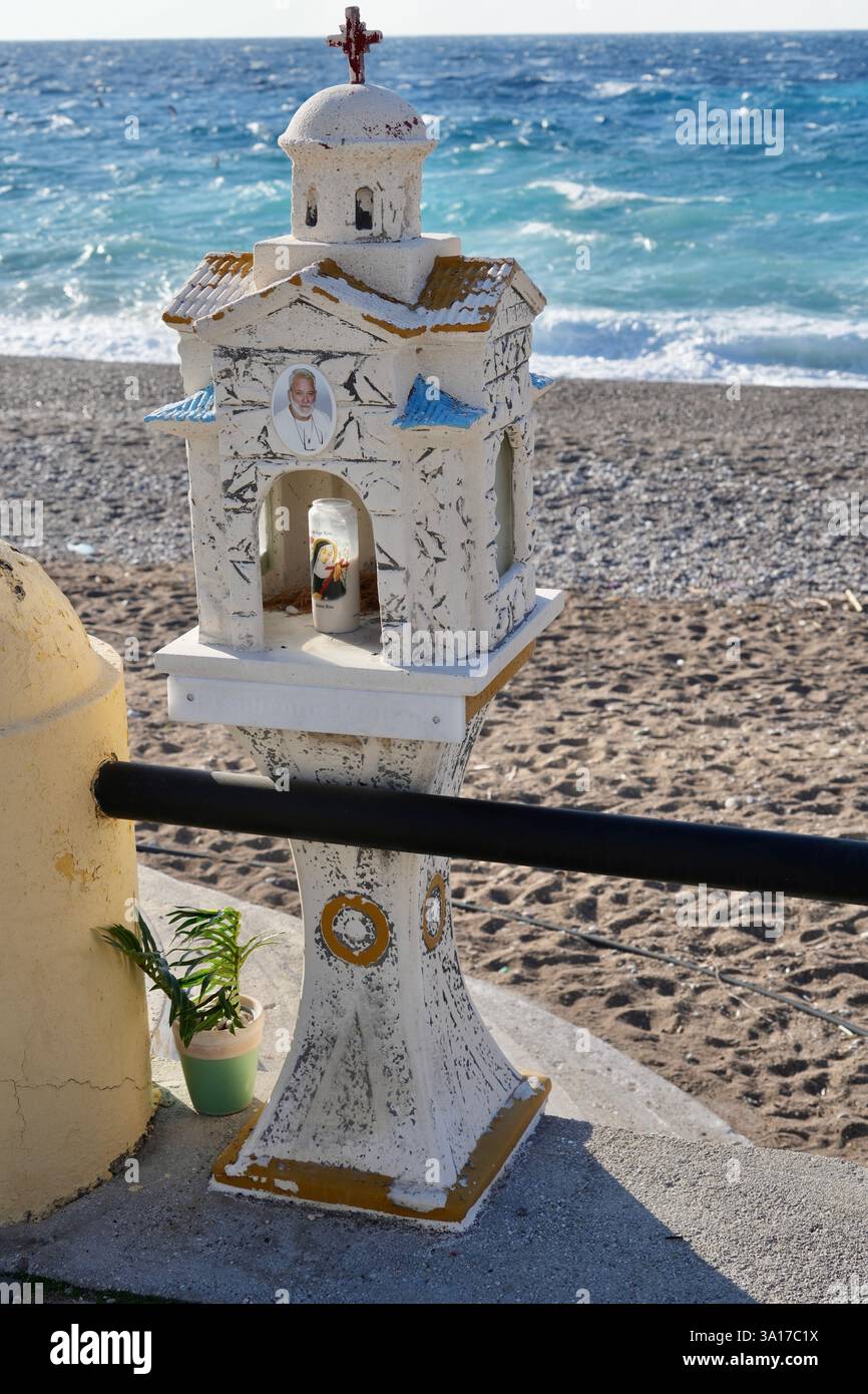 A Greek Orthodox Roadside Shrine with the beach and sea behind Stock ...