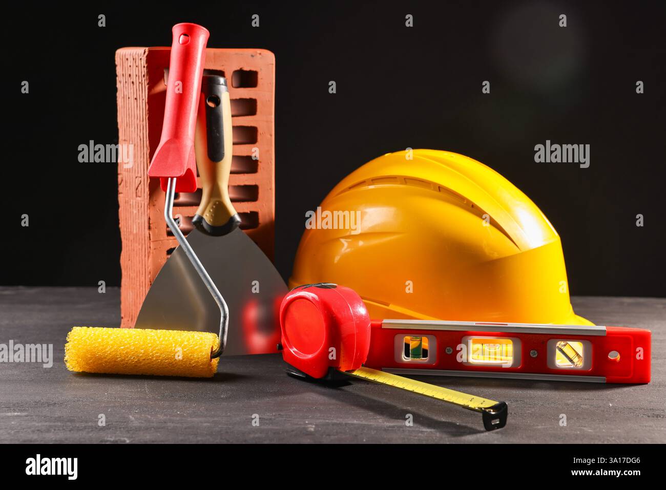 Different construction material and tools on black table Stock Photo ...