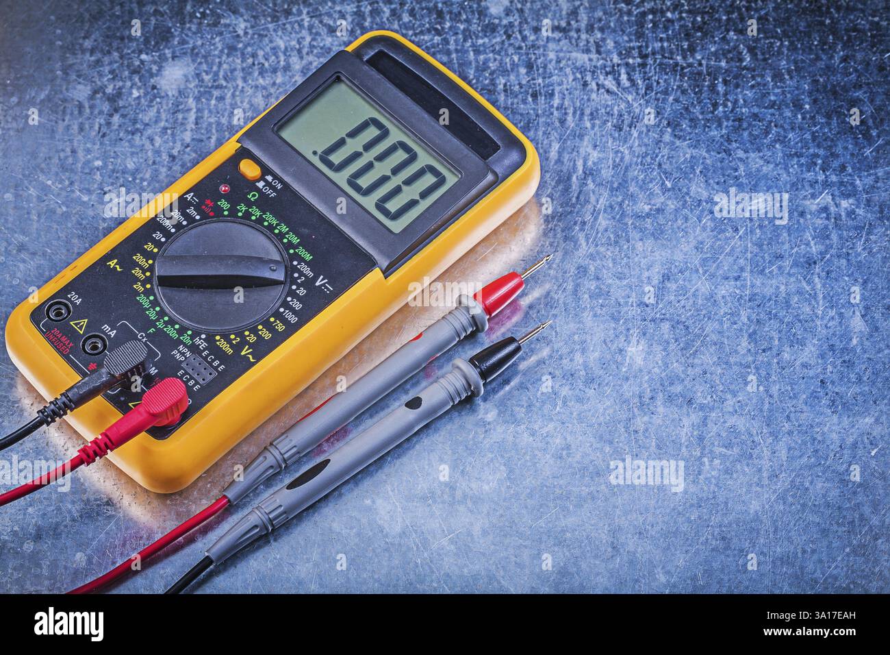 Digital electrical tester on metallic surface directly above ...