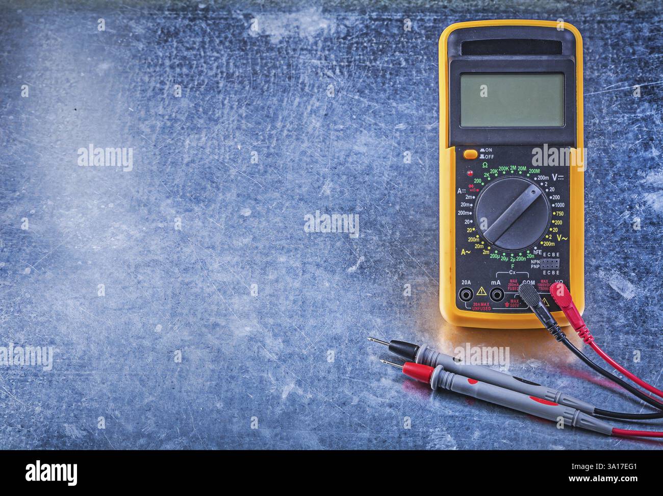 Digital multimeter on scratched metallic background copy space ...