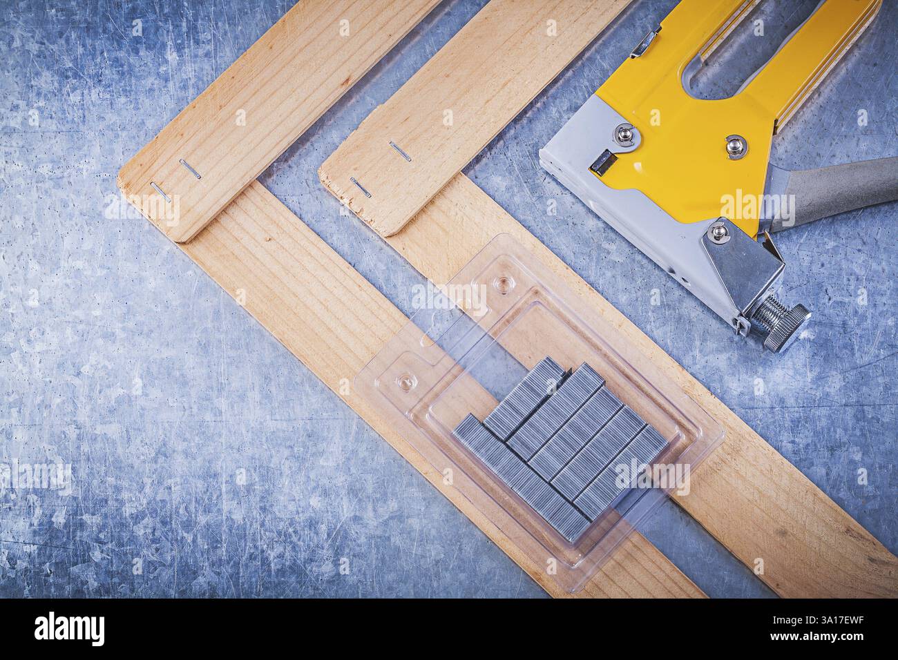 Collection of stapler gun metal staples wooden building board on ...