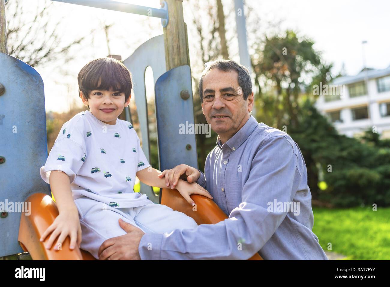Grandfather and grandson enjoying time together at the playground ...