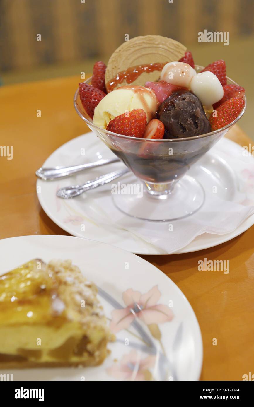 Strawberry parfait and pastry on plates at a Japanese cafe. Tokyo ...