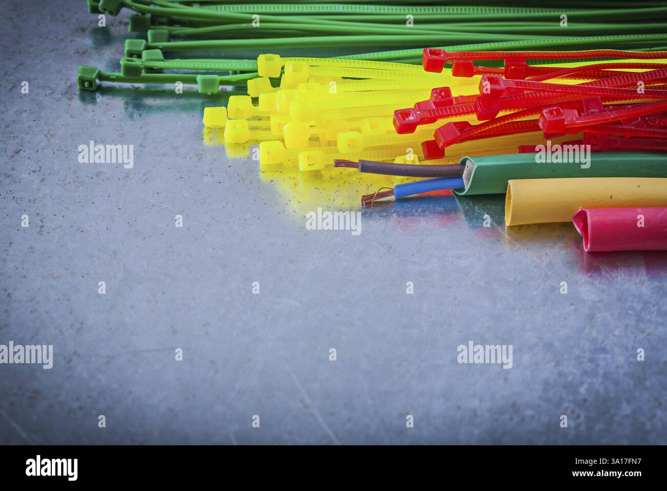 Collection of plastic cable ties electric wires on metallic background ...