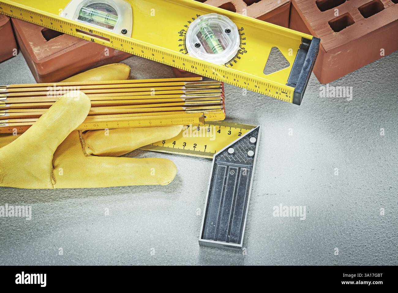 Red bricks construction level wooden meter square ruler on concrete ...