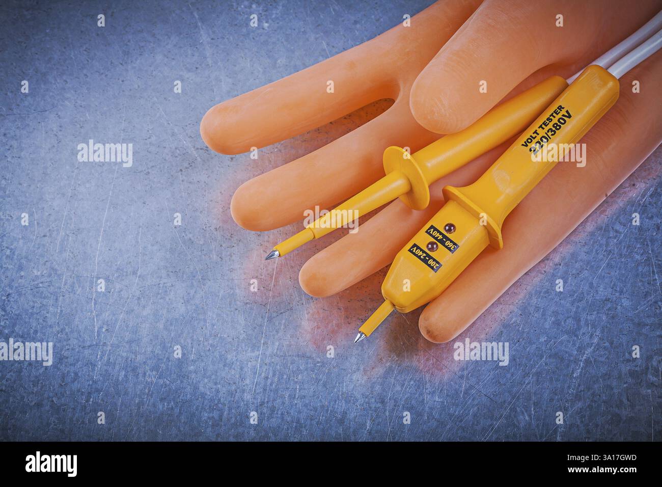 Electricians rubber gloves electric tester on metallic background Stock ...