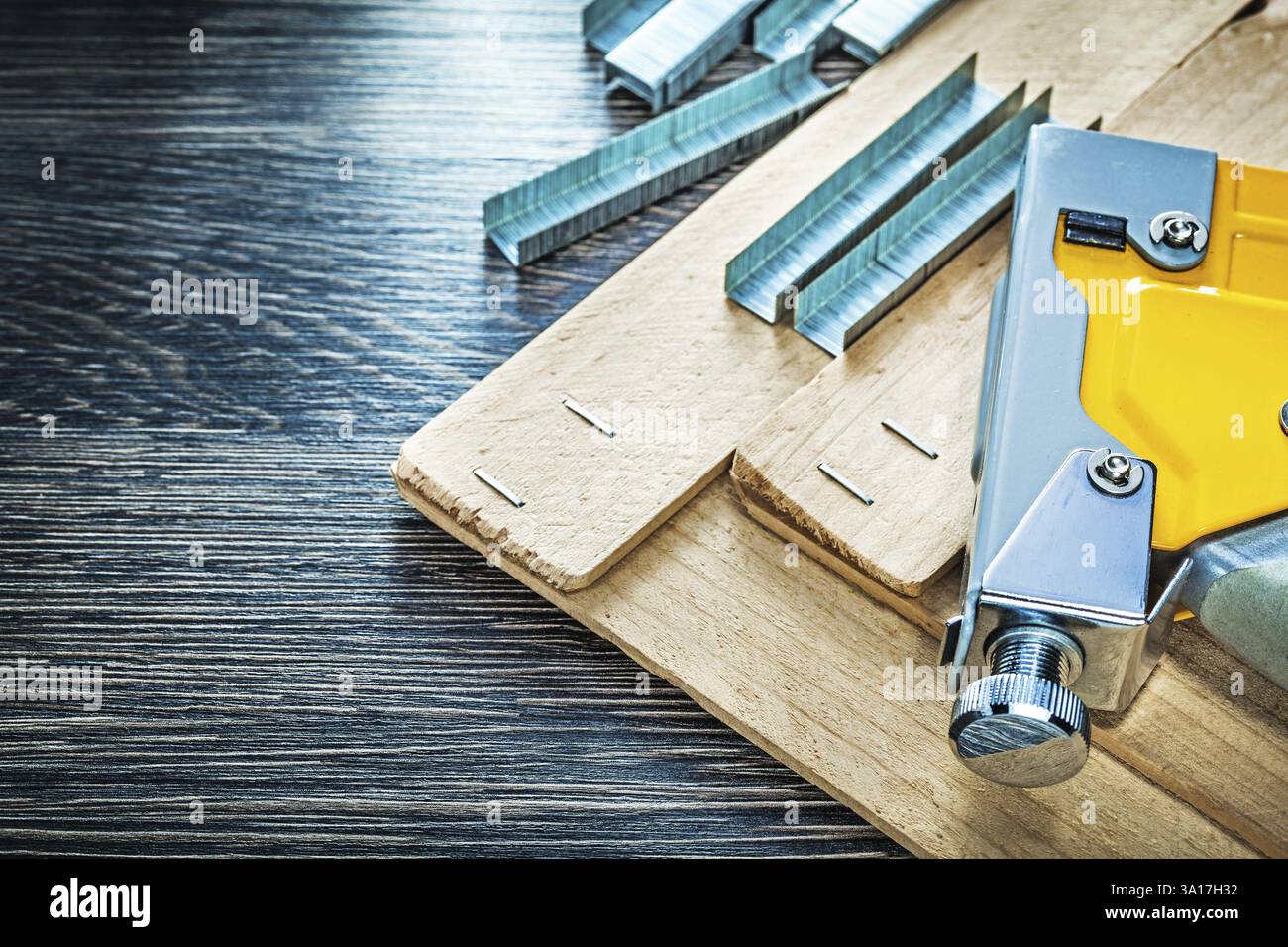 Composition of stapler metal staples wooden planks Stock Photo - Alamy