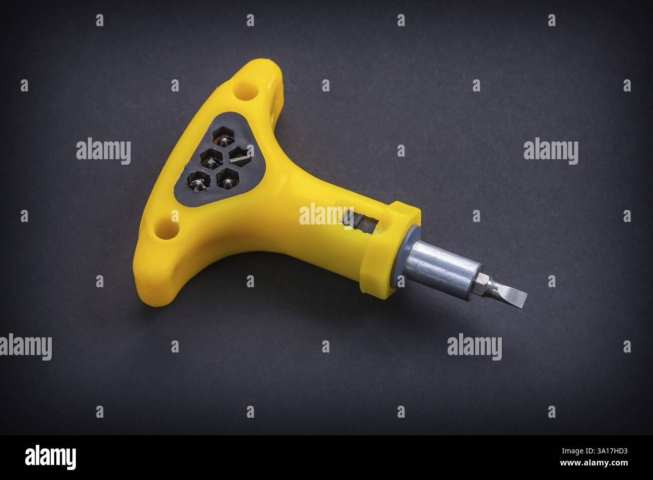 Close up yellow hand screwdriver on black background Stock Photo - Alamy