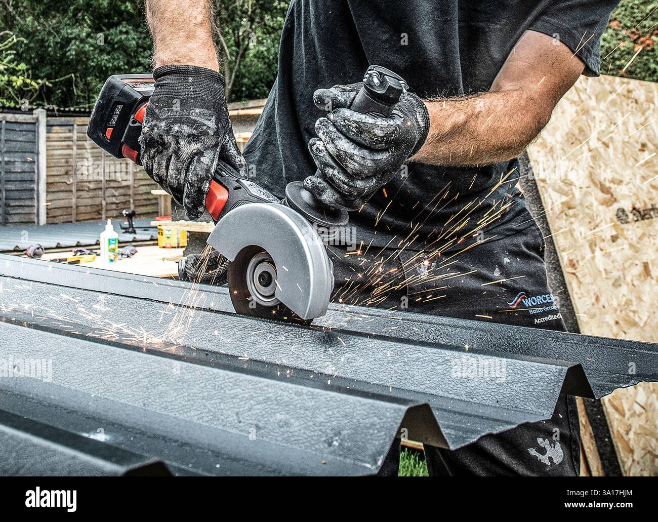 A male metalworker using an angle grinder cutting metal creating a lot of sparks Stock Photo - Alamy