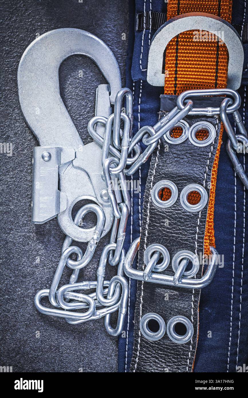 Construction safety strap with metal chain on black background ...