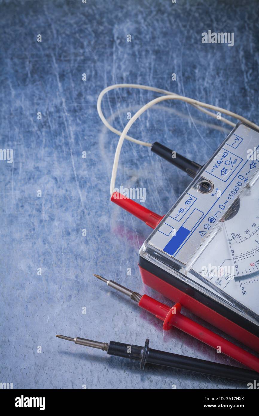 Electrician's multimeter on scratched metallic surface construction ...