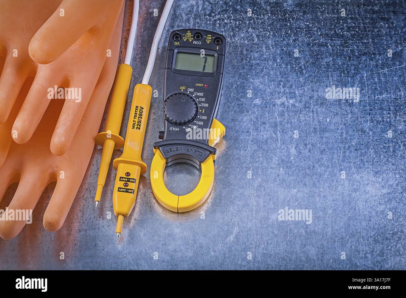 Digital clamp meter electrical tester insulating rubber gloves on ...