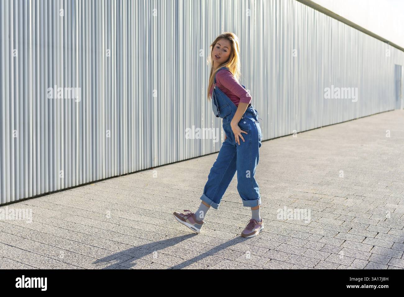 Talented young blonde woman dancing urban style outdoors, showcasing ...