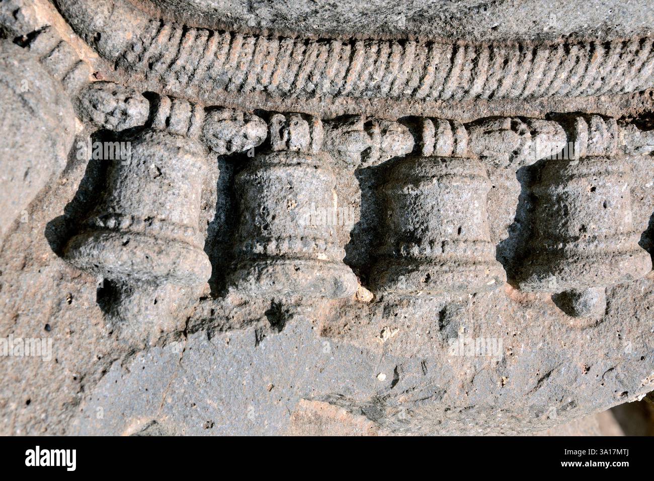 Carved stone artifacts displayed near the Solah Khamba Masjid, Fort ...